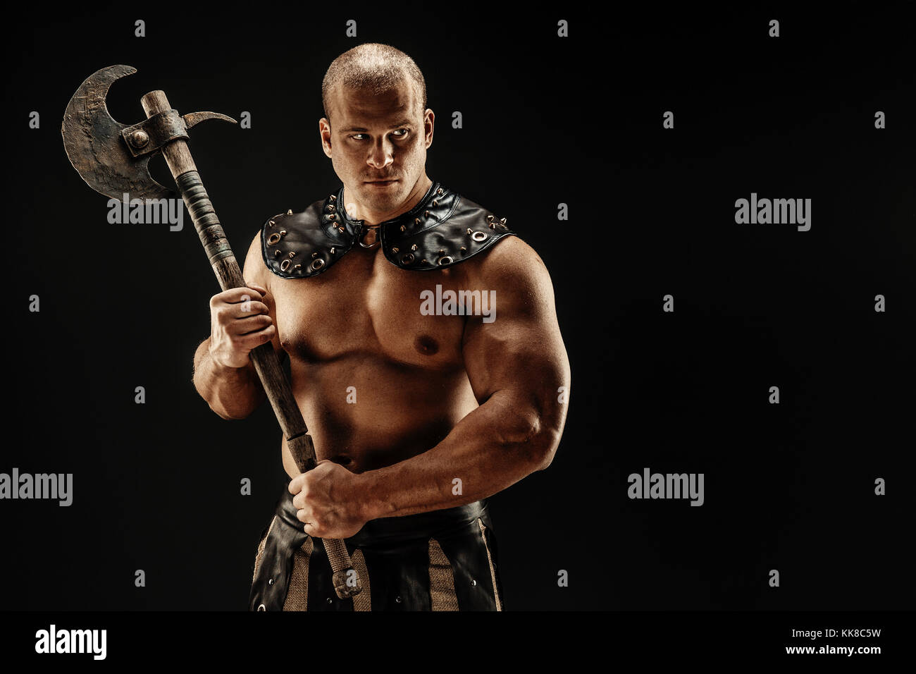 Severe barbarian in leather costume with hammer Stock Photo - Alamy