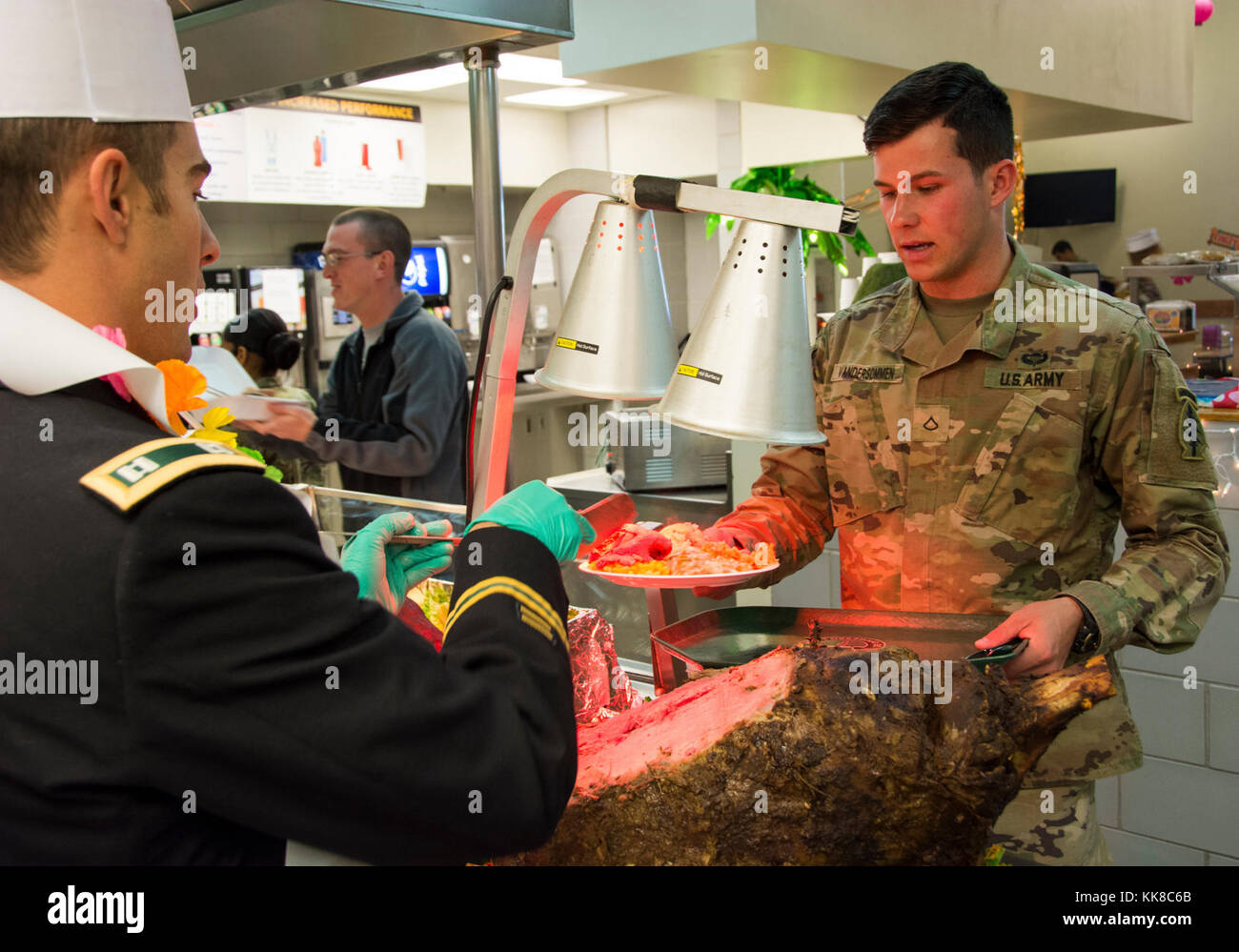 An officer assigned to 10th Special Forces Group (Airborne) serves food ...