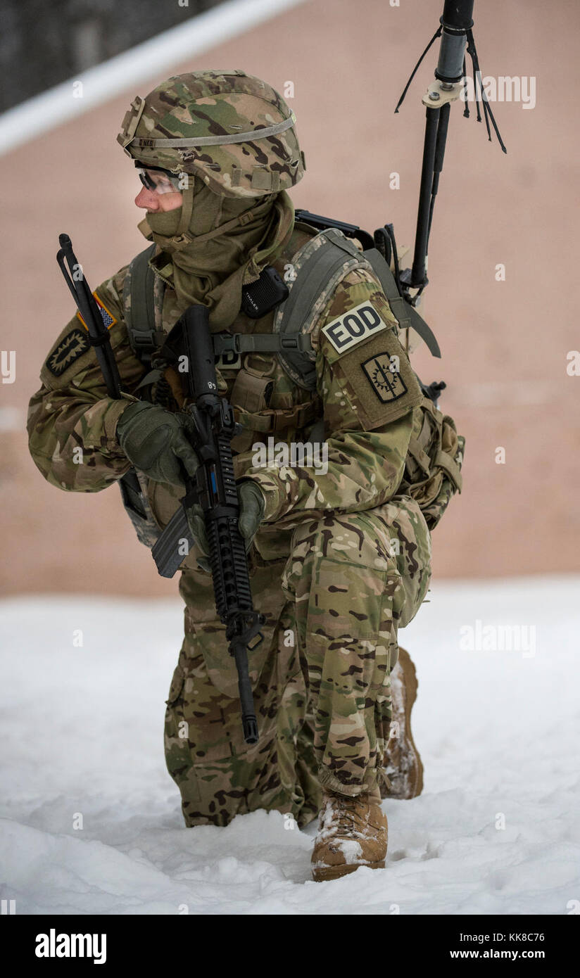A Soldier assigned to the 716th Explosive Ordnance Disposal Company scans the area for threats ...