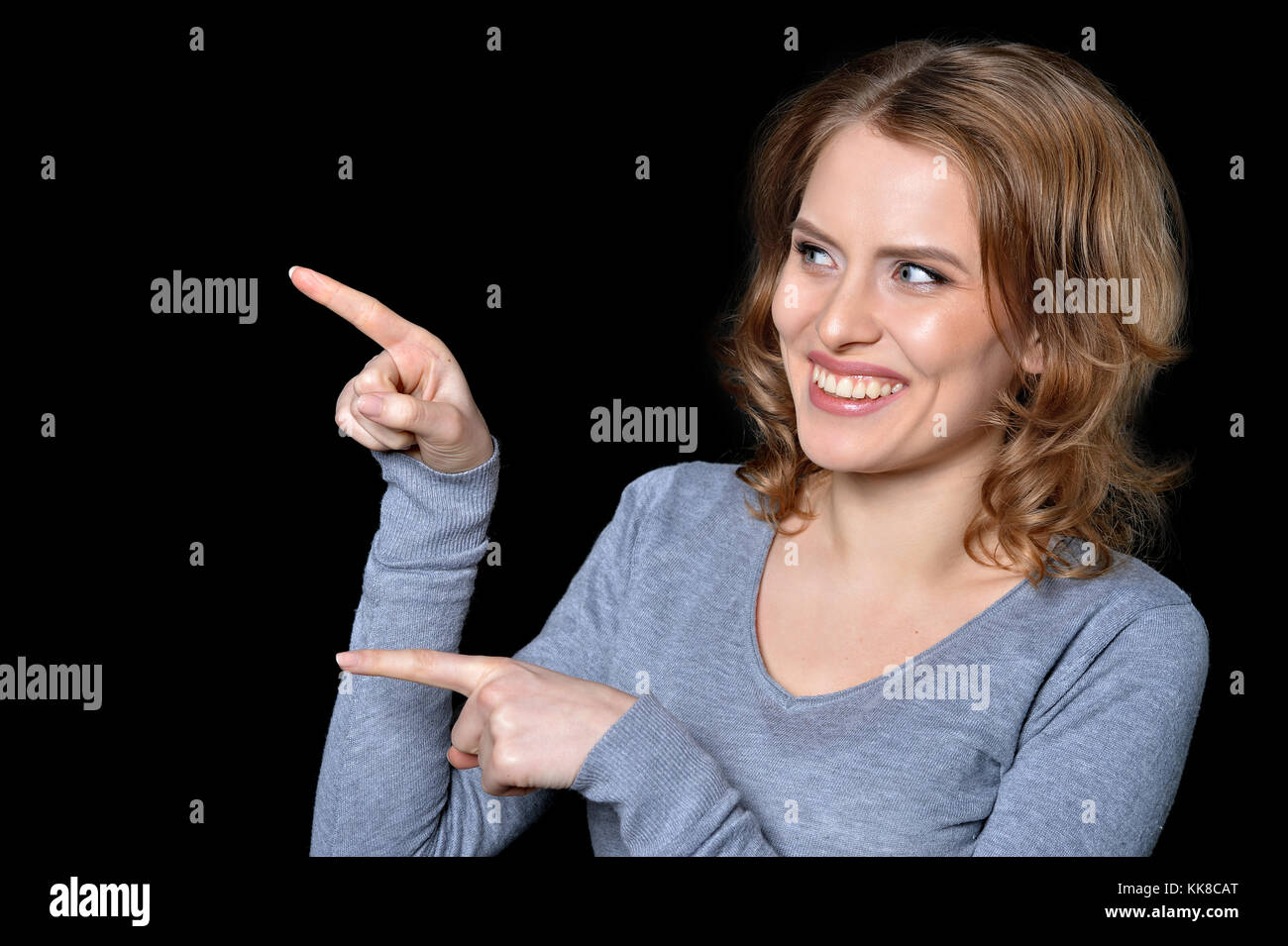 young woman showing something Stock Photo - Alamy