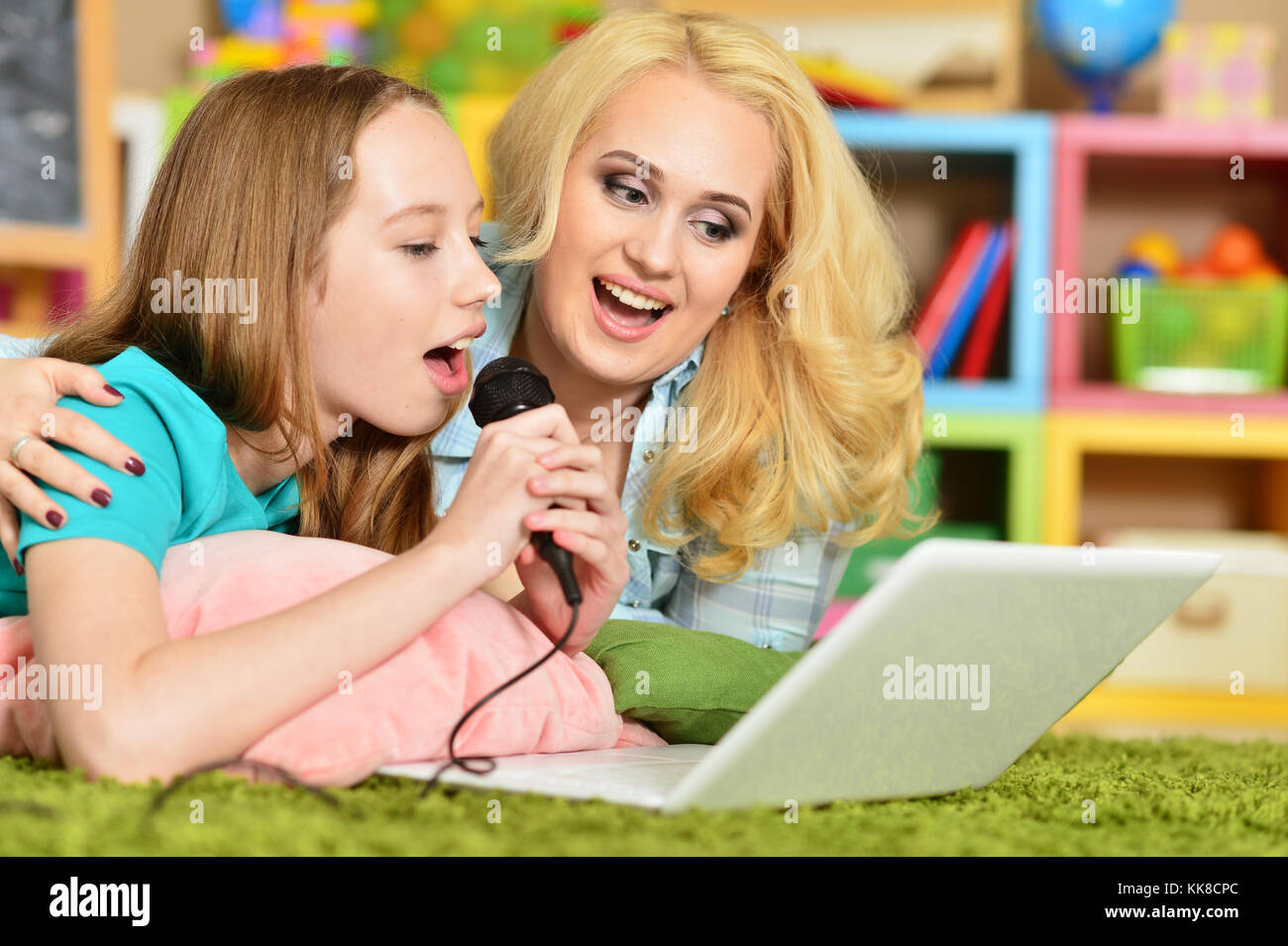 Mother daughter singing karaoke hi-res stock photography and images - Alamy