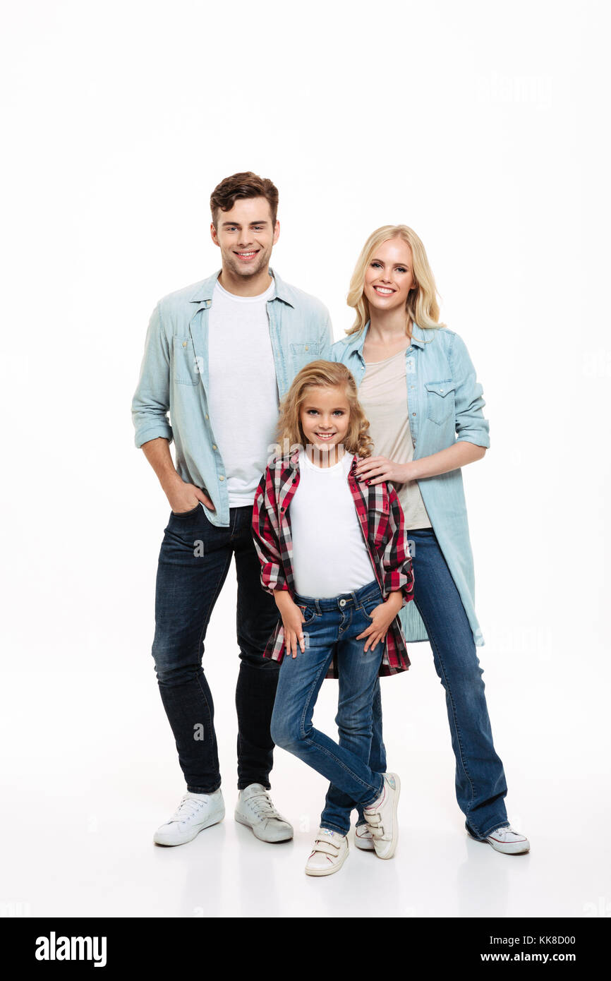 Full length portrait of a happy smiling family with a child standing ...