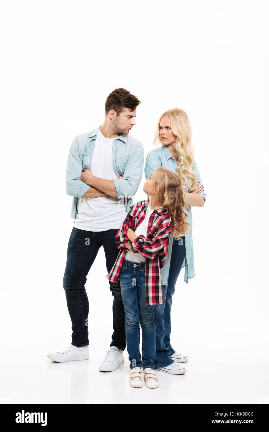 Full length portrait of an angry furious family with a child standing ...