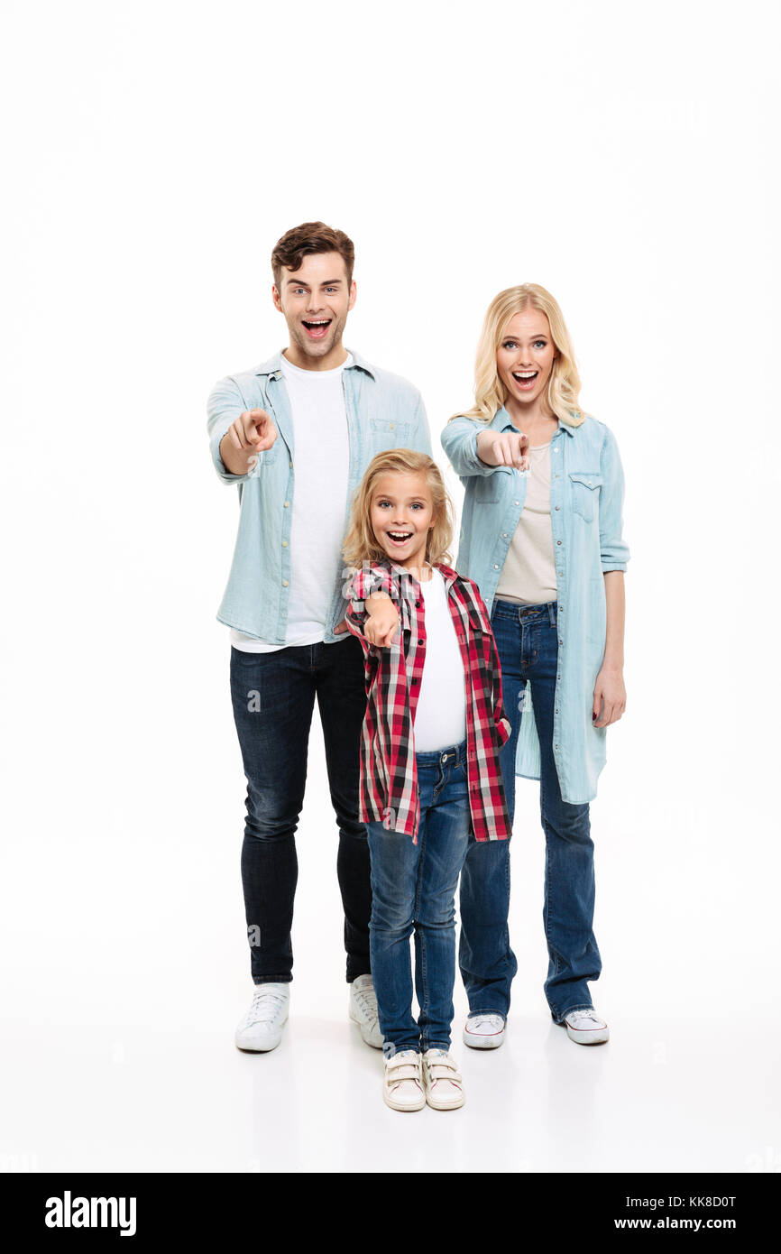 Full length portrait of a happy smiling family with a child standing ...