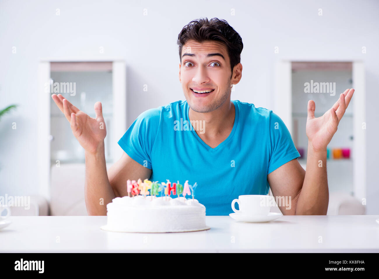 Young man celebrating birthday alone at home Stock Photo - Alamy