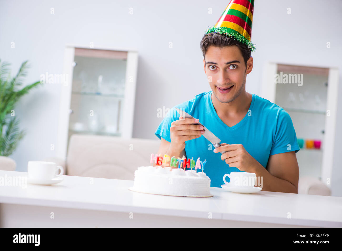 Young man celebrating birthday alone at home Stock Photo - Alamy