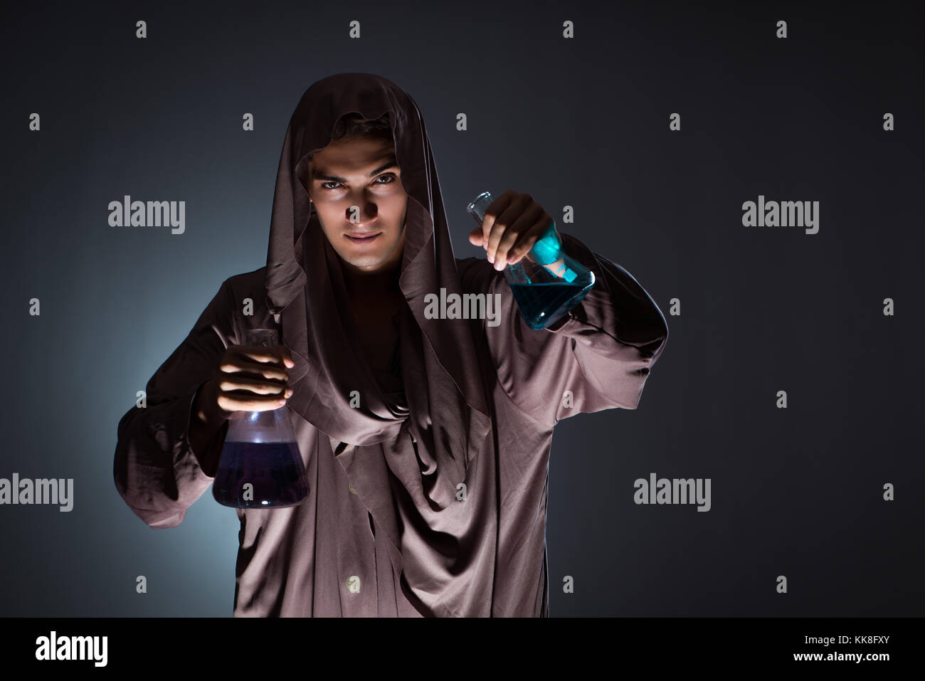 Alchemist doing experiments in alchemy concept Stock Photo - Alamy
