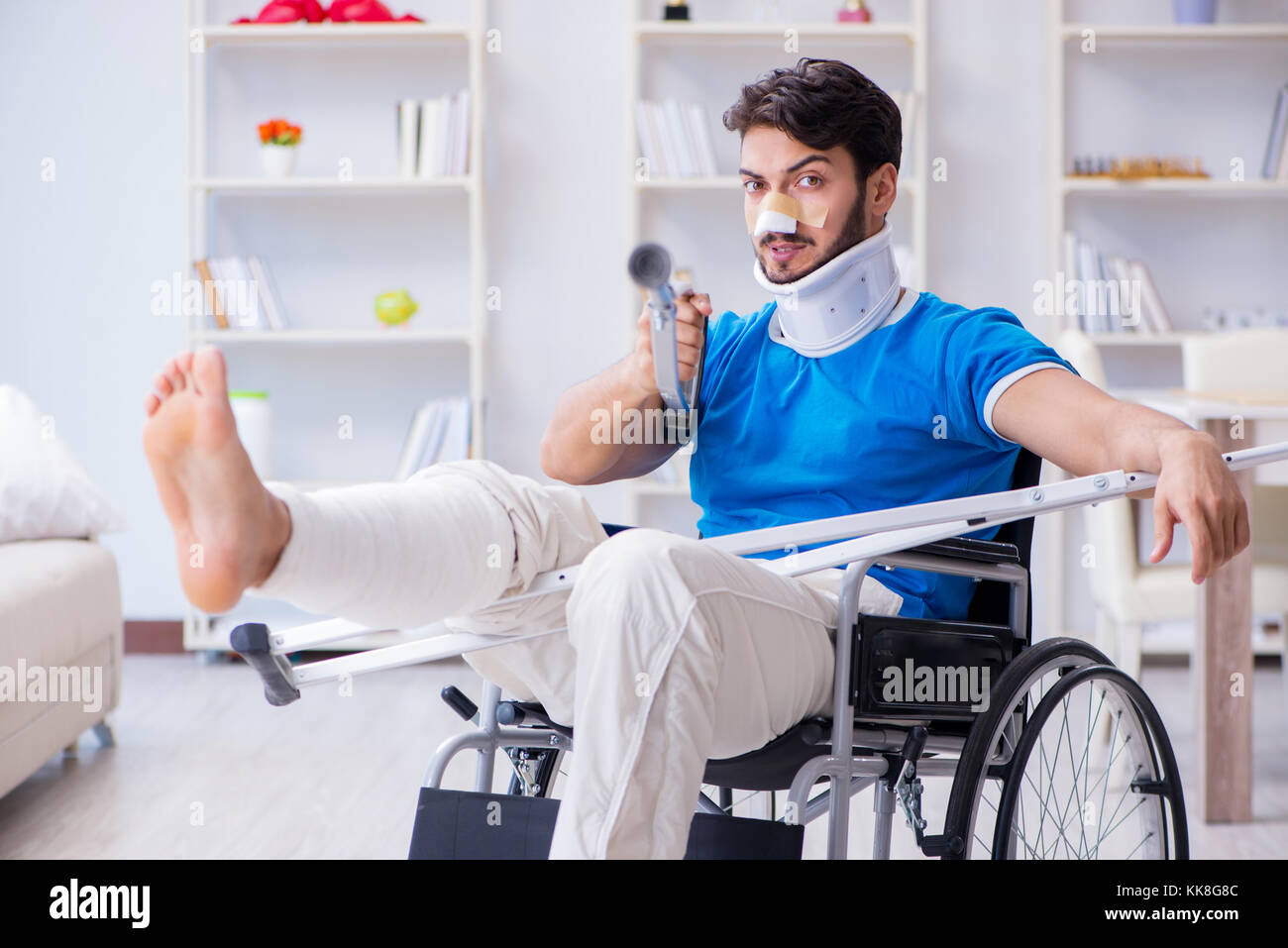 Injured young man recovering at home Stock Photo - Alamy