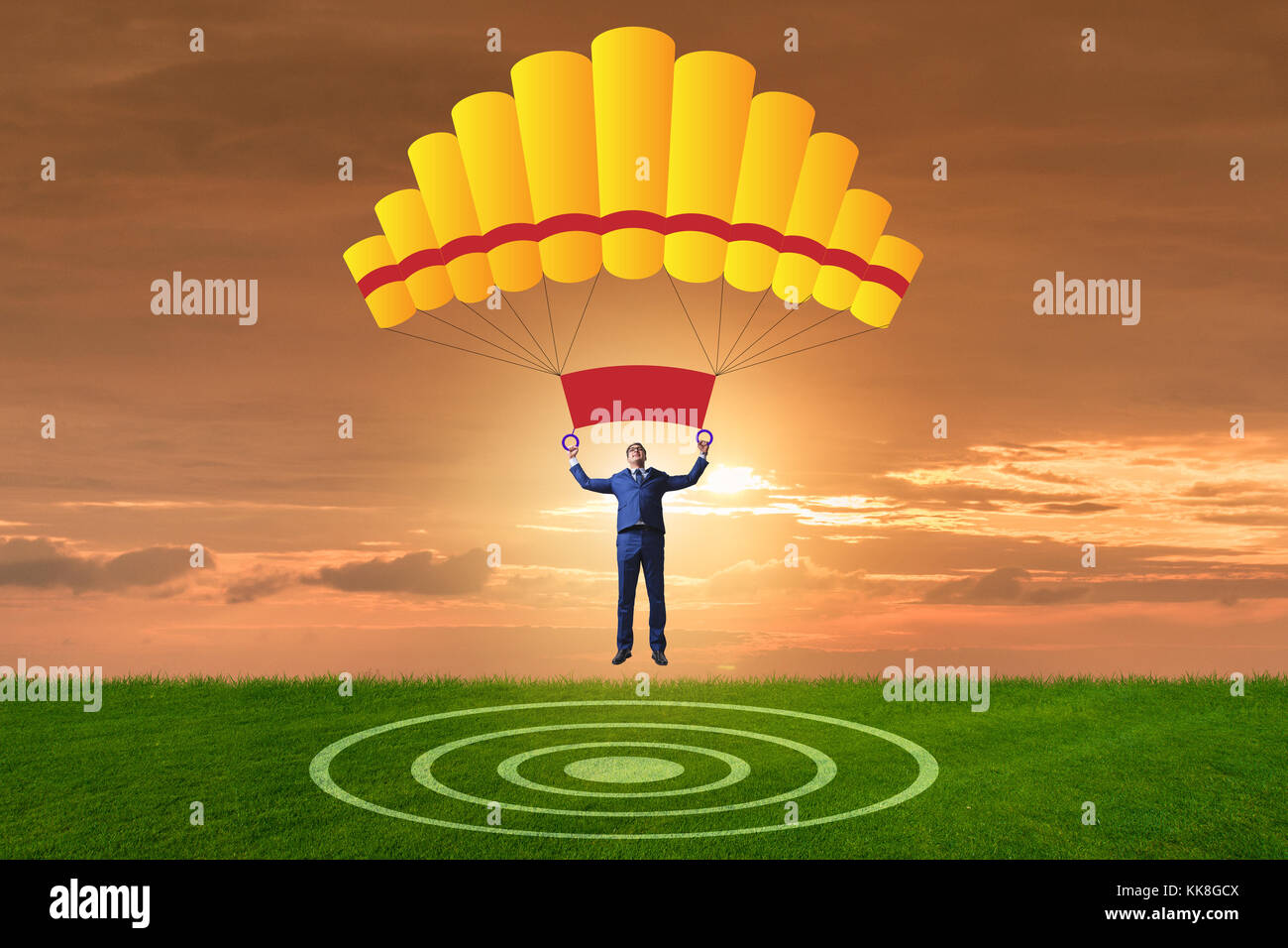 Young businessman falling on parachute in business concept Stock Photo ...