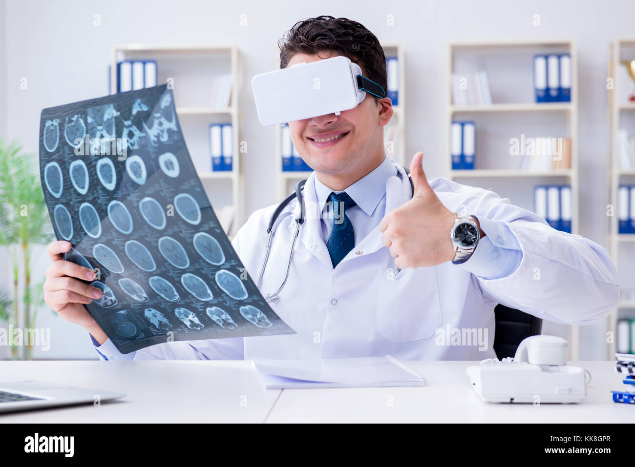 Young doctor looking at MRI scan through VR glasses Stock Photo - Alamy