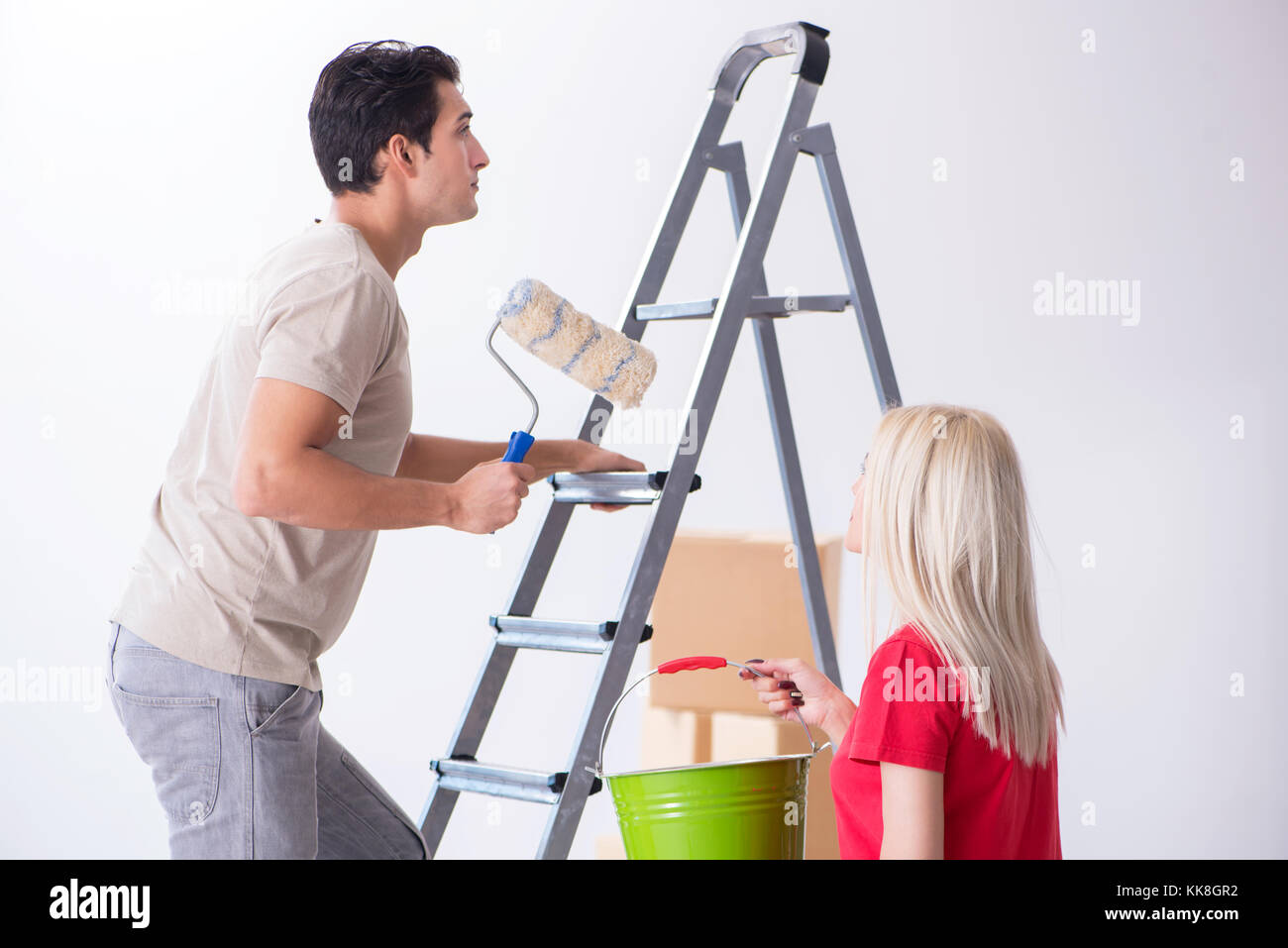 Young family doing painting job during home renovation Stock Photo - Alamy