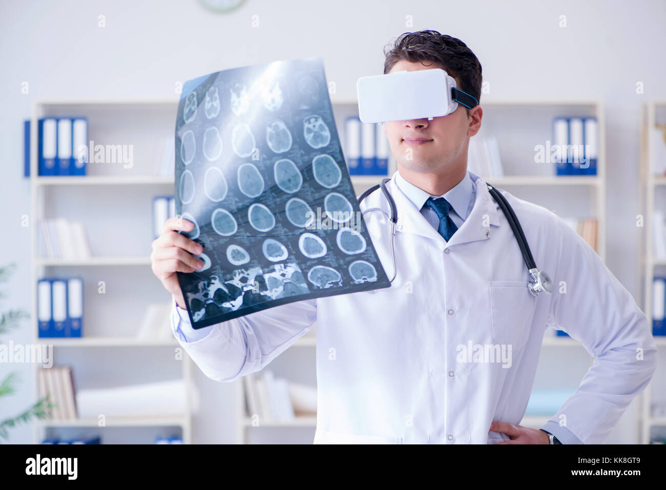 Young doctor looking at MRI scan through VR glasses Stock Photo - Alamy