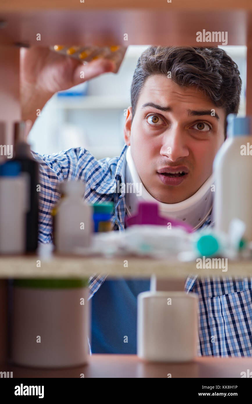 Sick ill man looking for medicines at farmacy shelf Stock Photo - Alamy