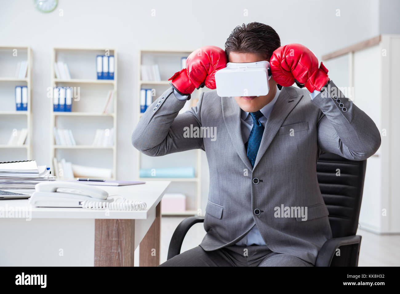 Man boxing in the office with virtual reality goggles Stock Photo - Alamy
