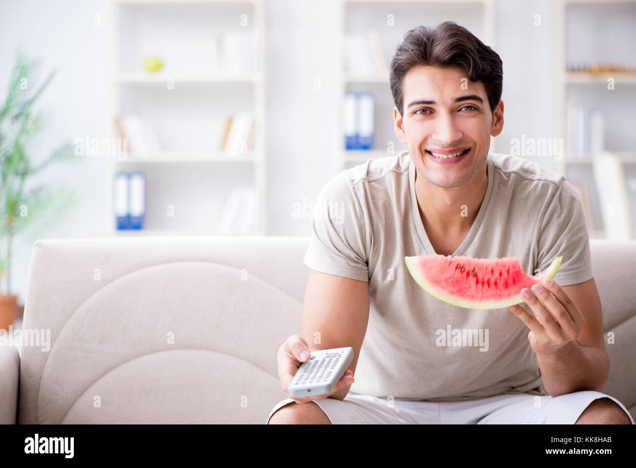 Man eating watermelon at home Stock Photo - Alamy
