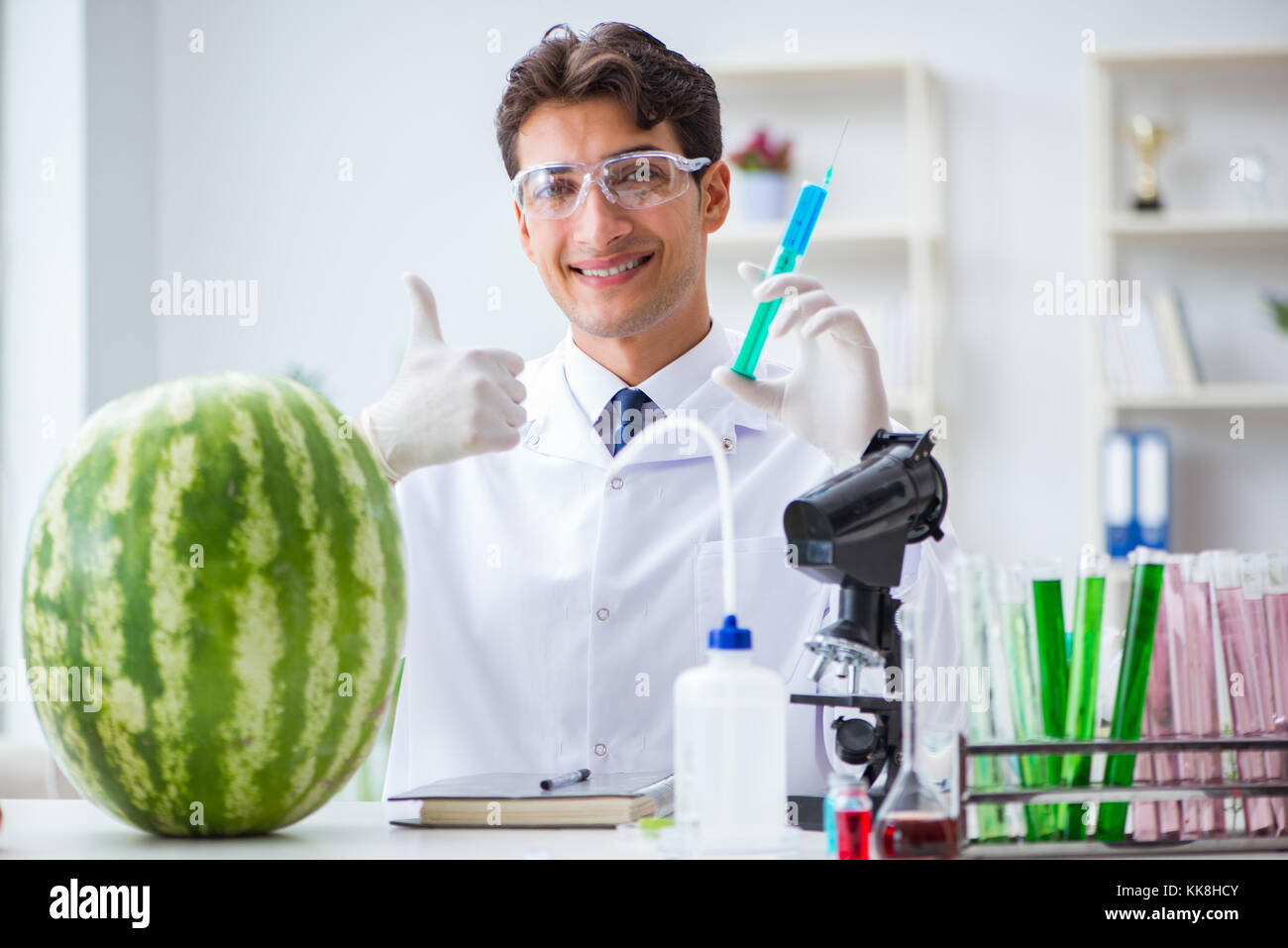 Scientist testing watermelon in lab Stock Photo - Alamy