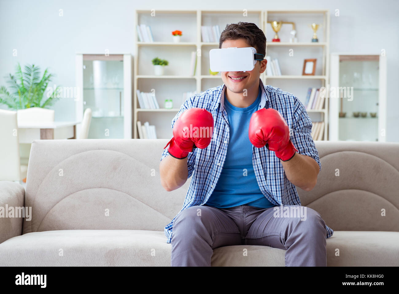 Man wearing virtual reality VR glasses playing boxing game Stock Photo ...