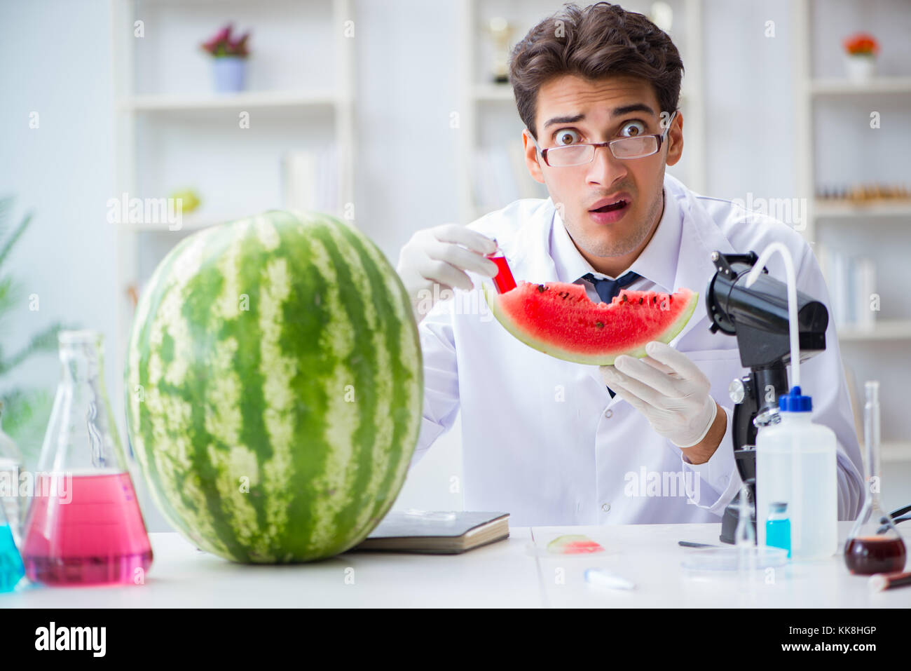 Scientist testing watermelon in lab Stock Photo - Alamy