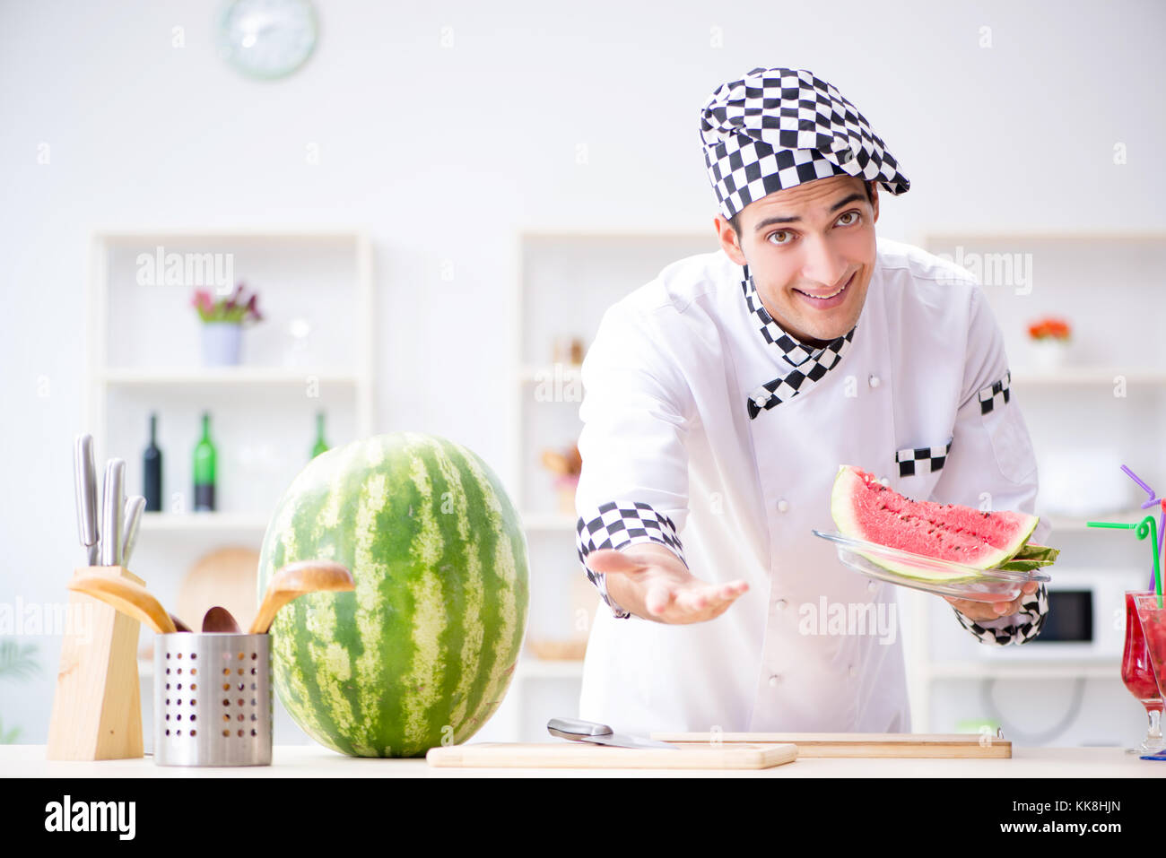 Male cook with watermelon in kitchen Stock Photo - Alamy
