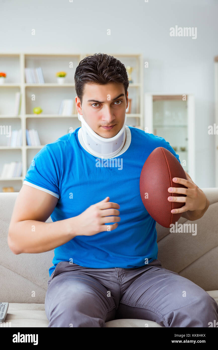 Man with neck injury watching american football at home Stock Photo - Alamy