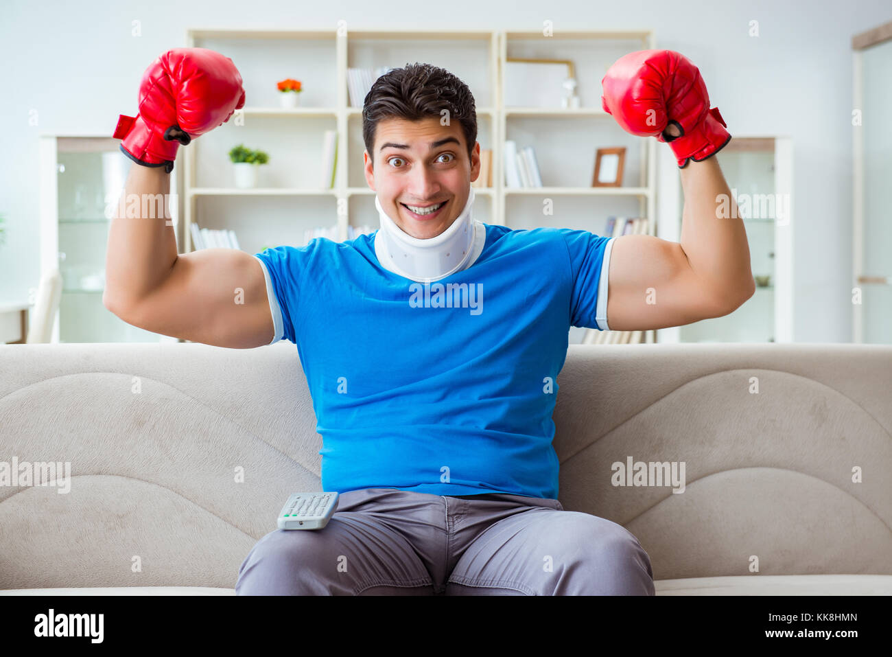 Man with neck injury watching boxing at home Stock Photo - Alamy