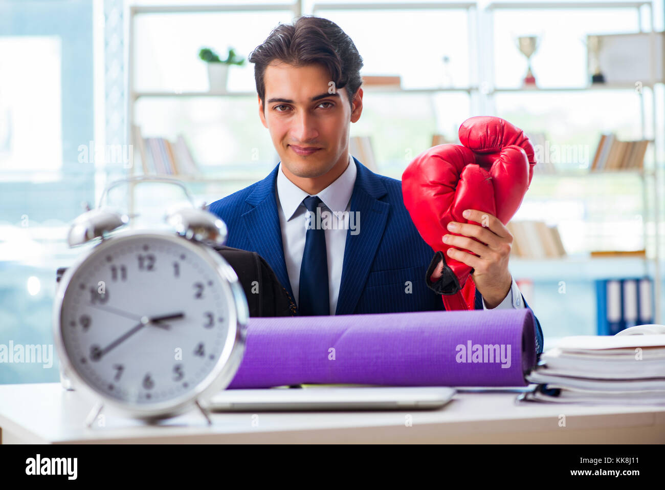 Man with boxing gloves in the office Stock Photo - Alamy