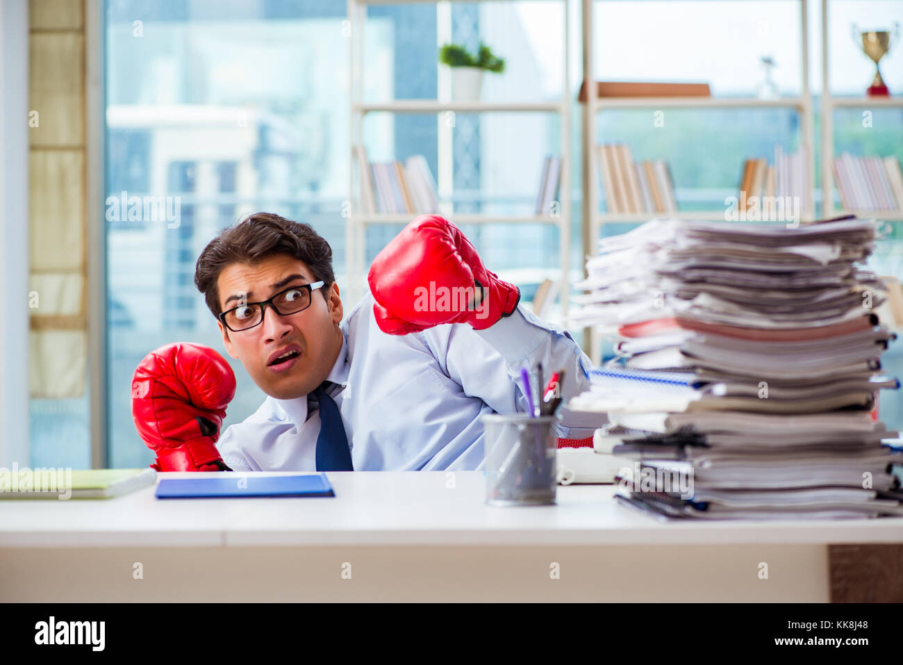 Businessman with boxing gloves in the office Stock Photo - Alamy