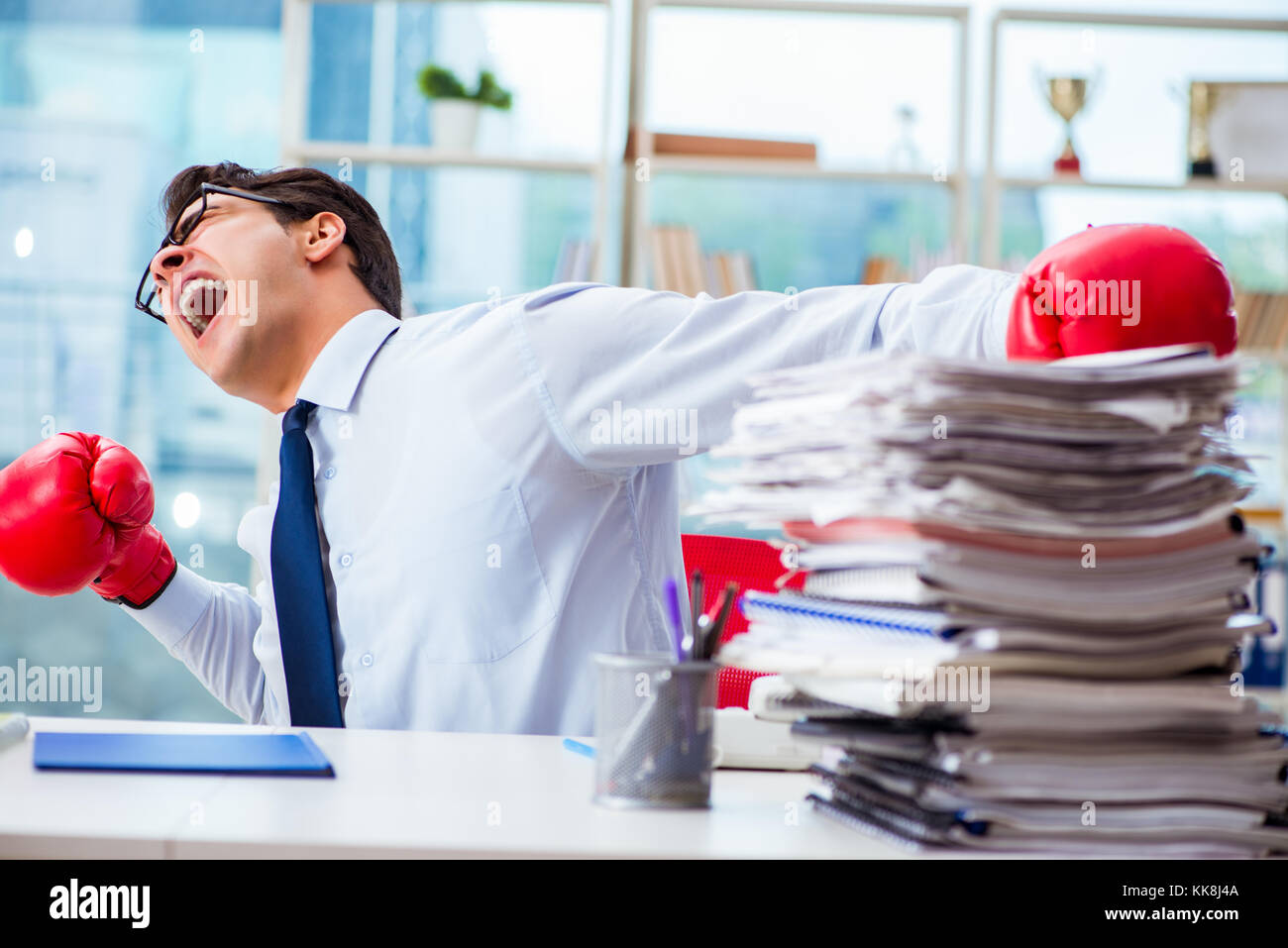 Businessman with boxing gloves in the office Stock Photo - Alamy
