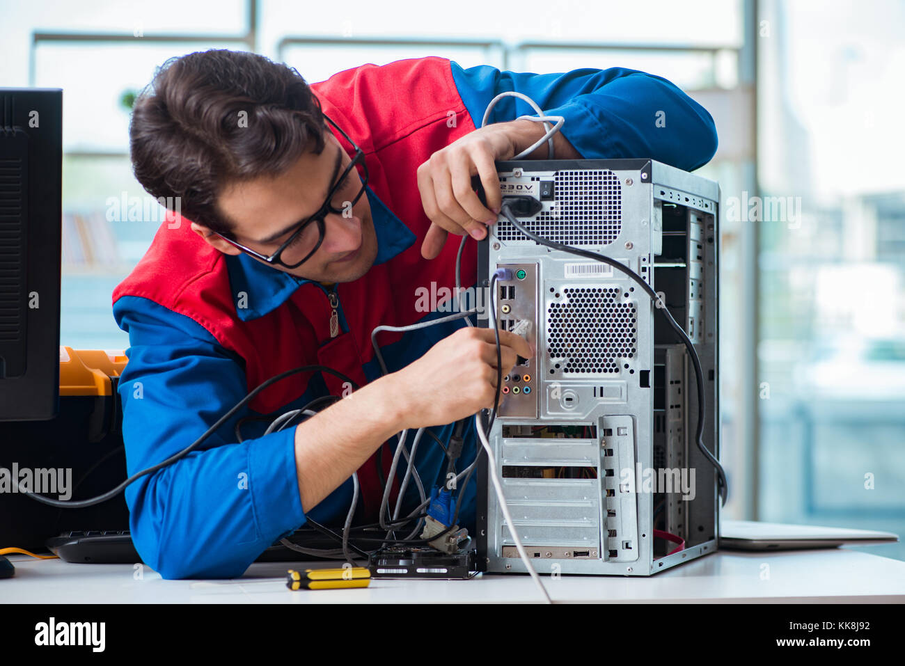 Computer repairman working on repairing computer in IT workshop Stock ...