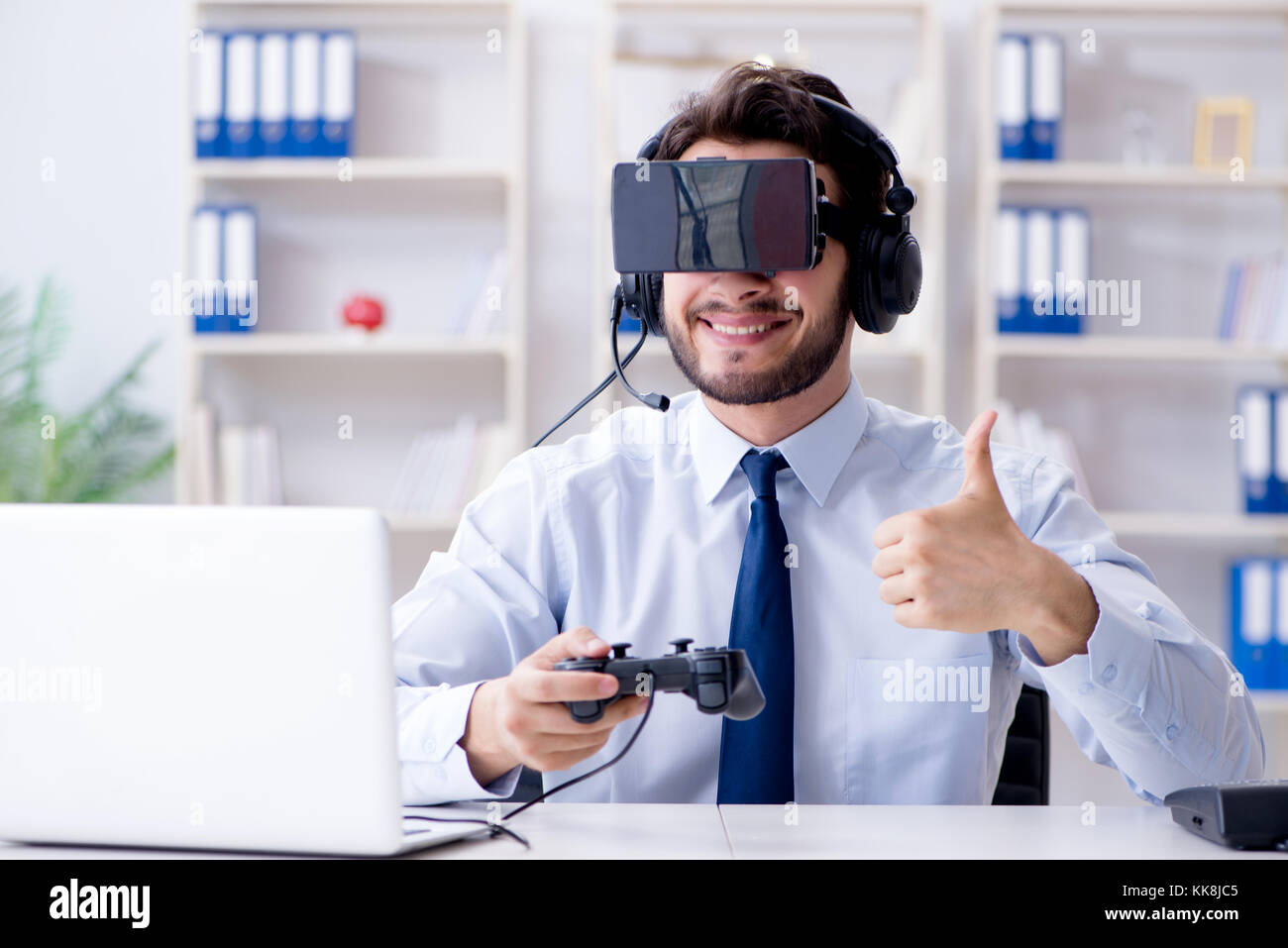 Businessman gamer in office playing games Stock Photo - Alamy