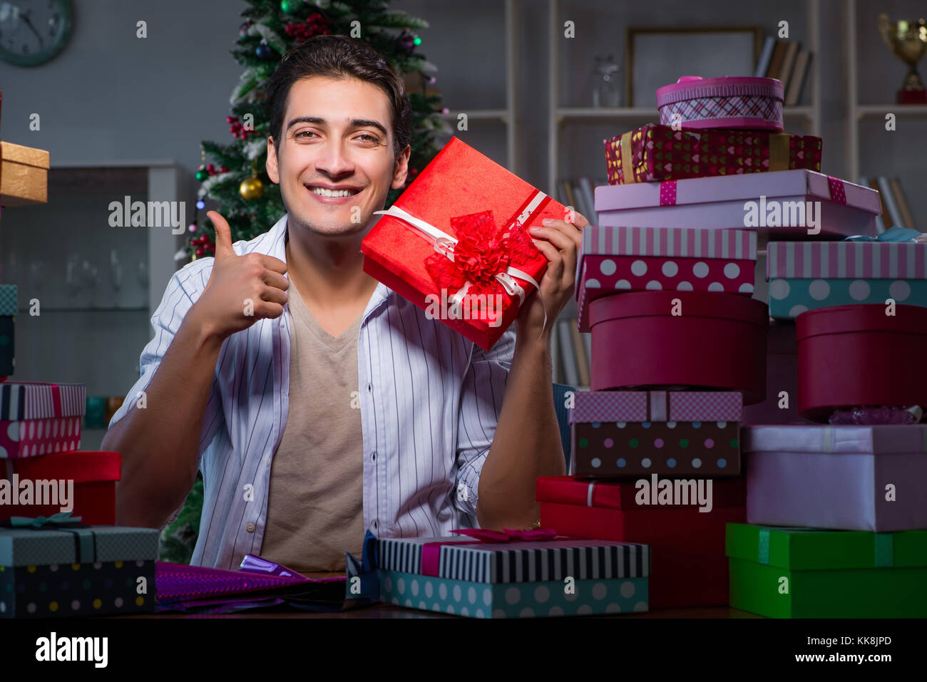 Man with many christmas gifts in boxes Stock Photo - Alamy