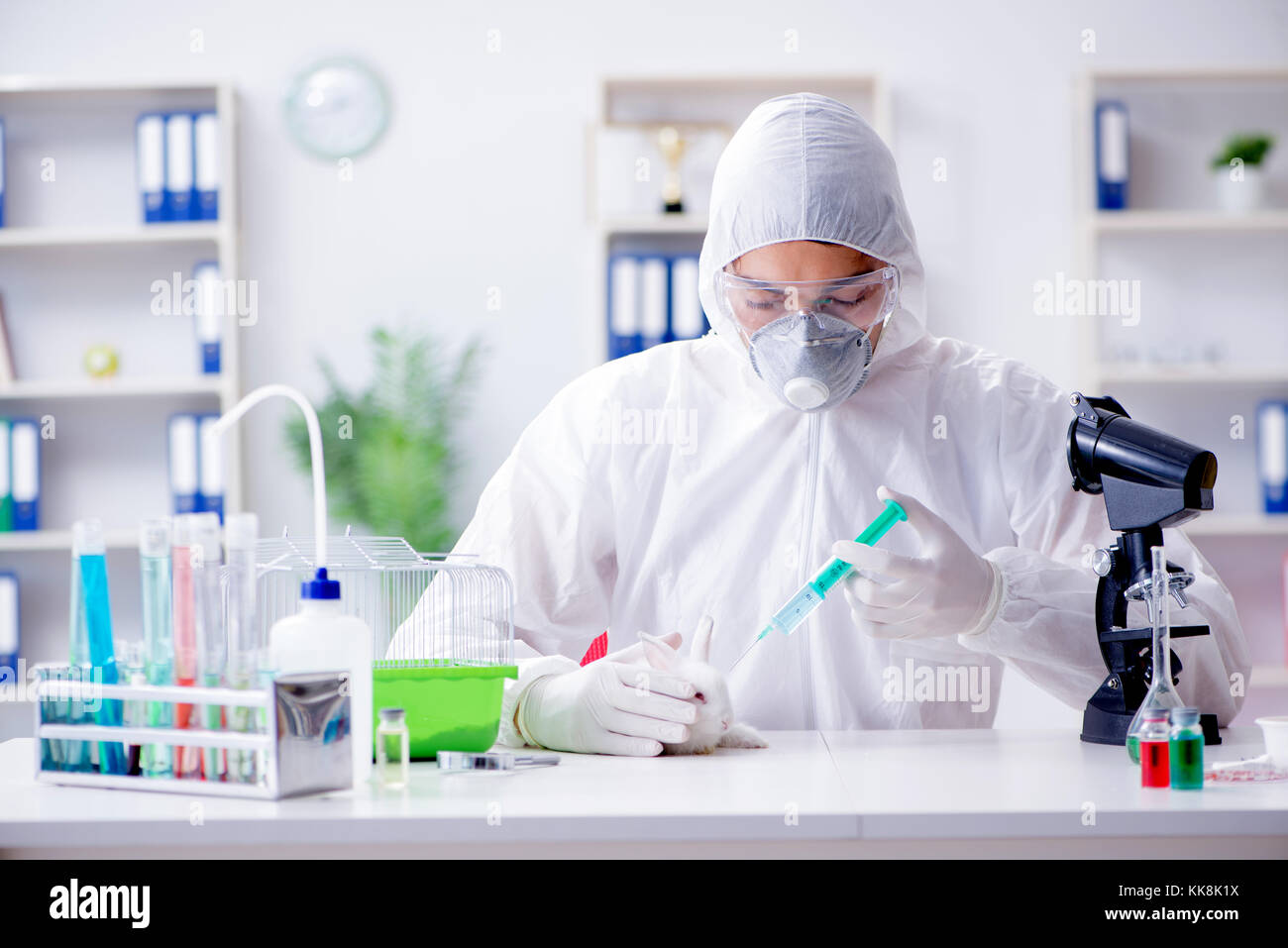 Scientist doing animal experiment in lab with rabbit Stock Photo - Alamy