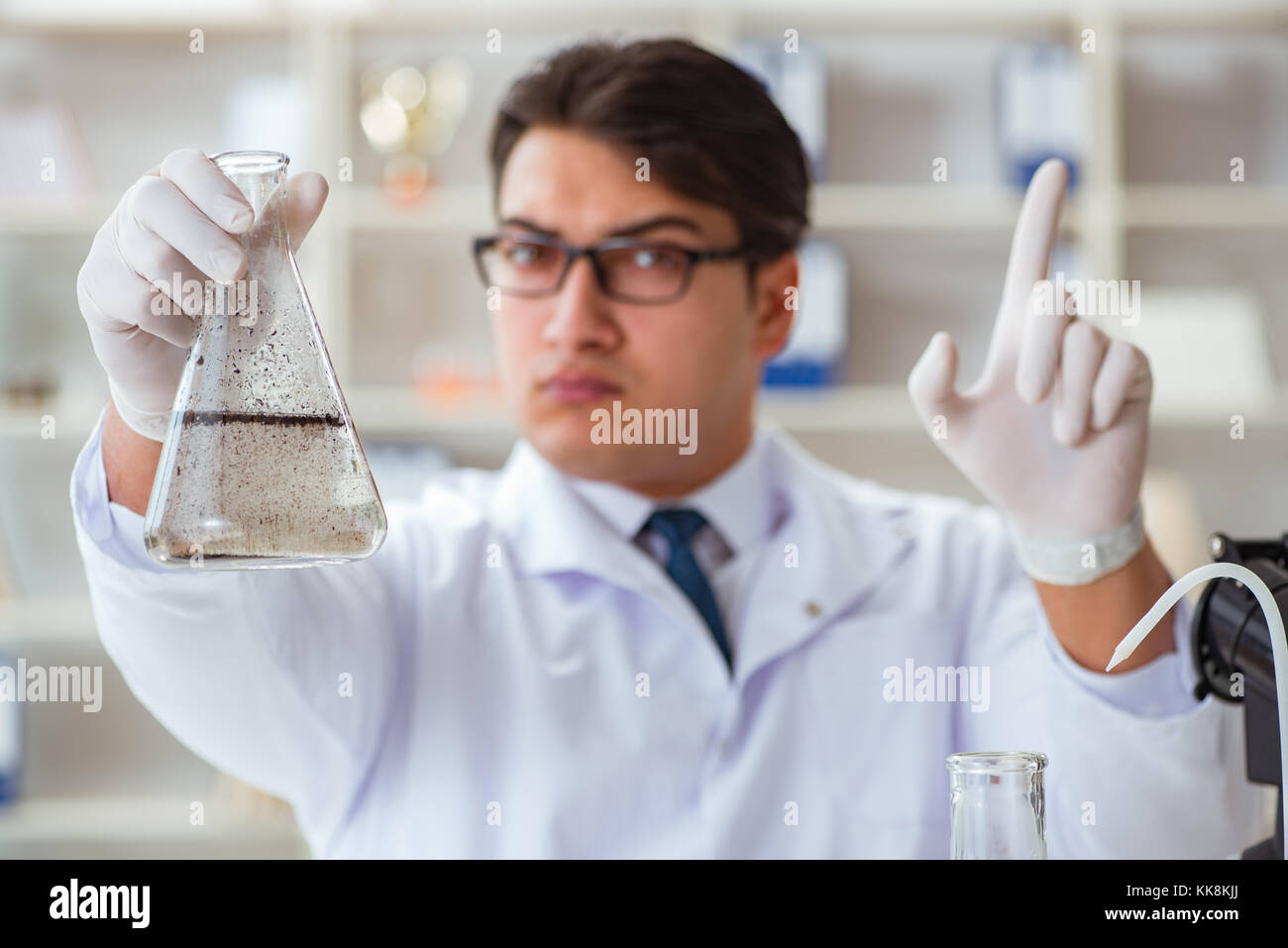 Young researcher scientist doing a water test contamination experiment ...