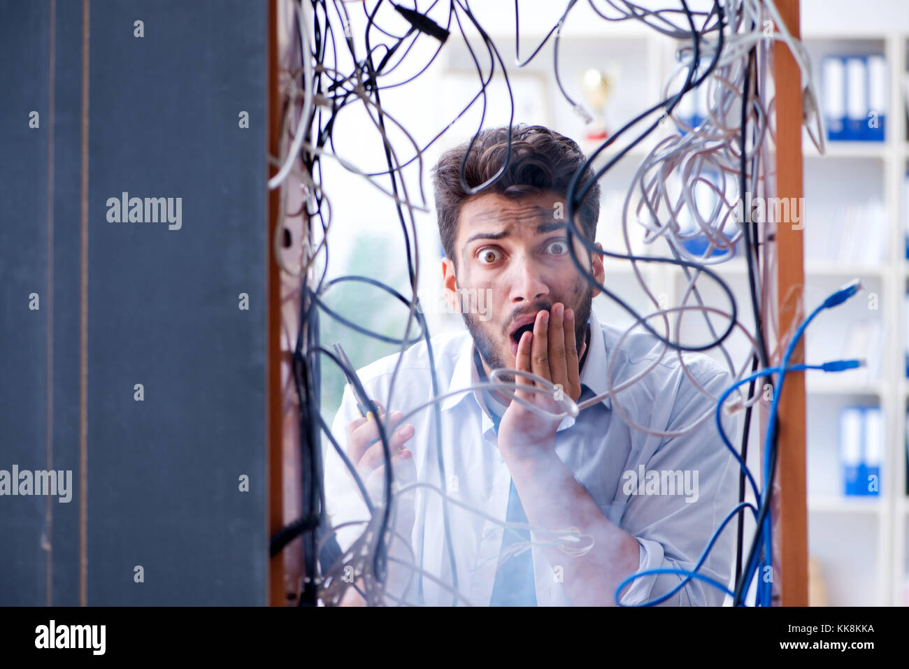 Electrician trying to untangle wires in repair concept Stock Photo - Alamy