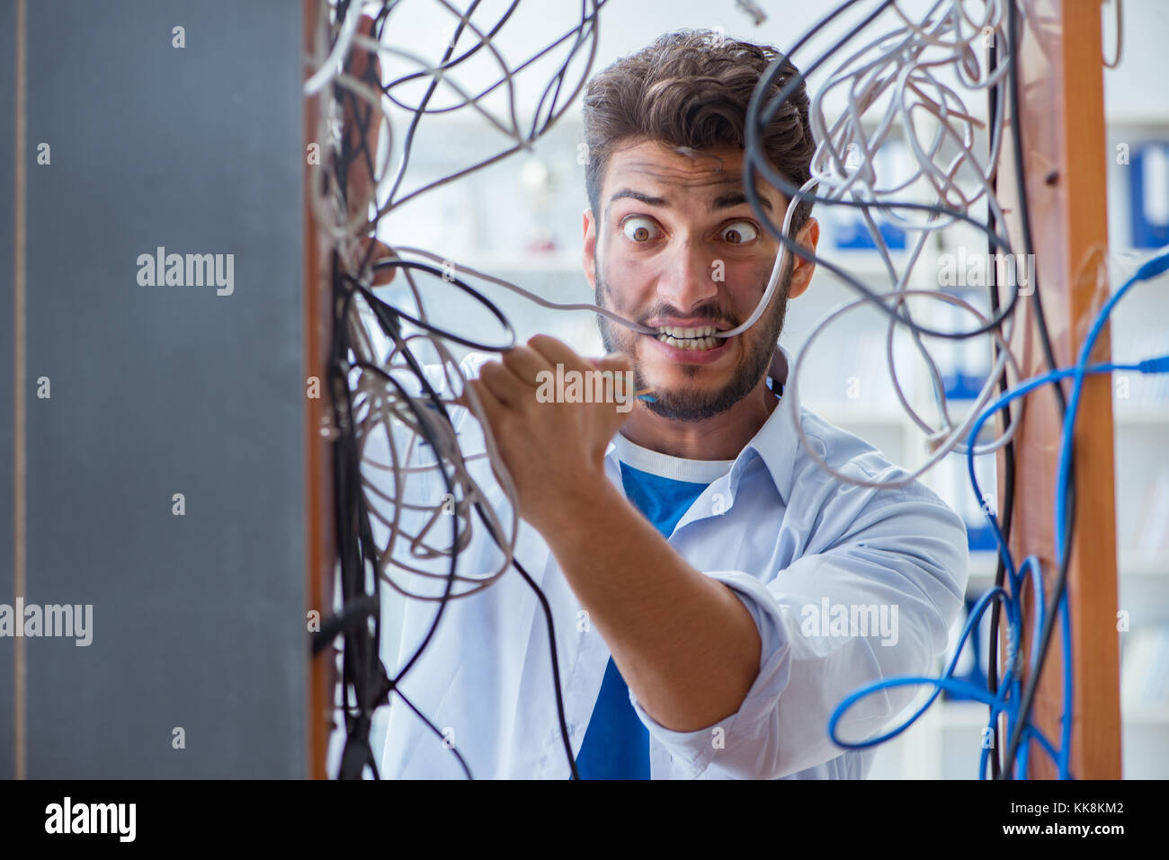 Computer repairman working on repairing network in IT workshop Stock ...