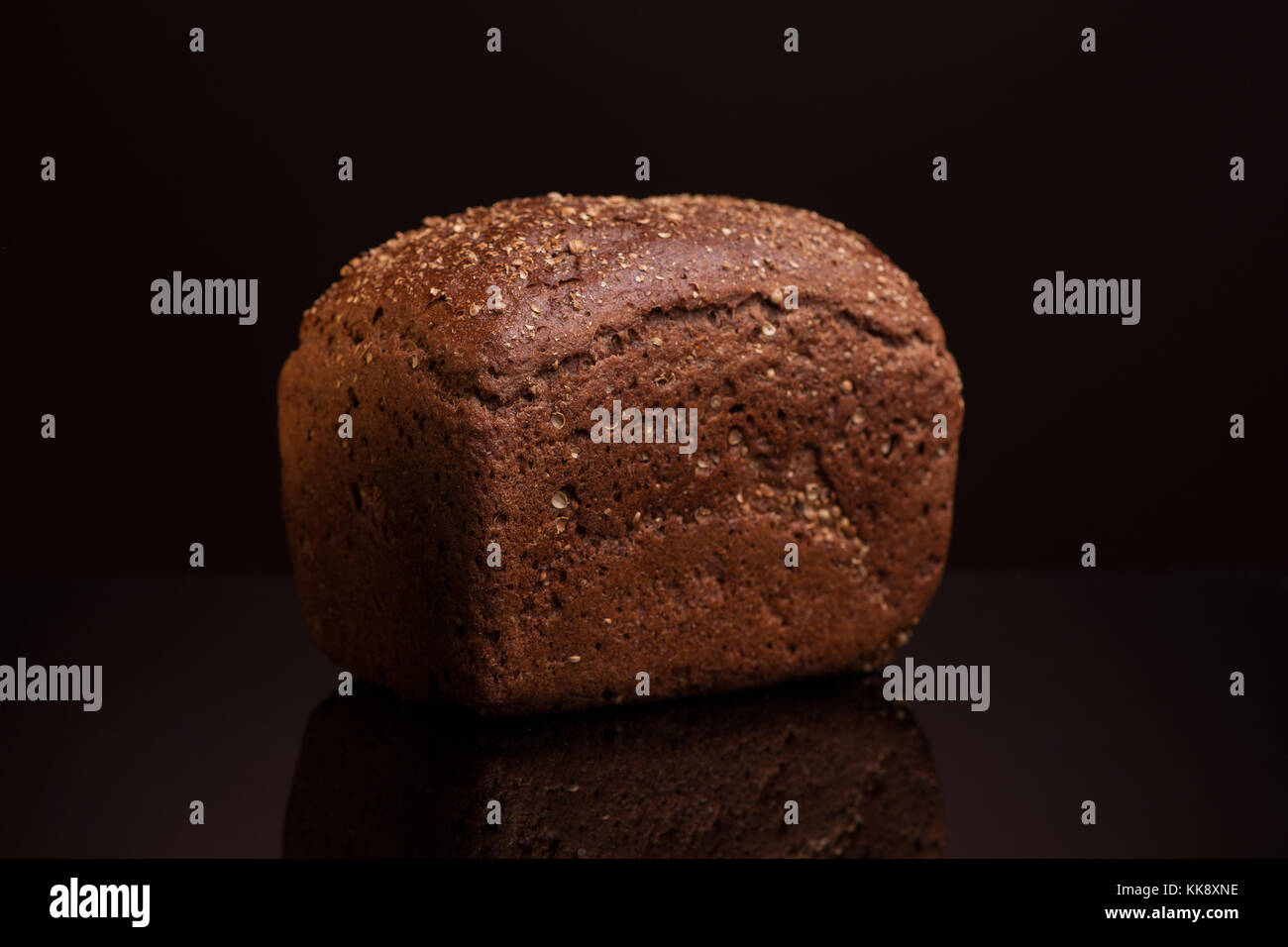 one loaf of bread close-up on a dark background with reflection Stock ...