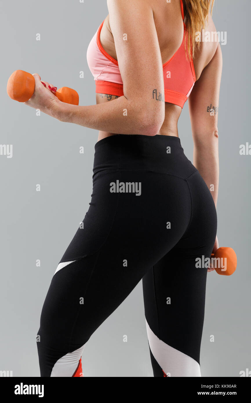 Cropped side view image of a strong sports woman doing exercise with ...
