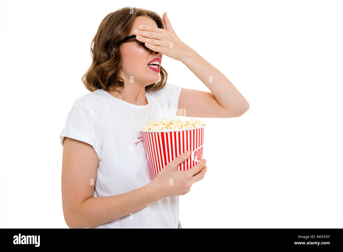 Image of scared caucasian woman holding pop corn wearing 3d glasses ...