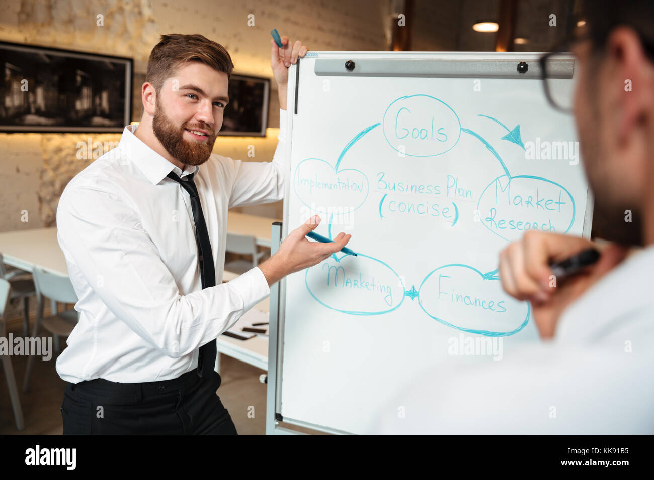 Two smart businessmen having a meeting and discussing business plan on ...