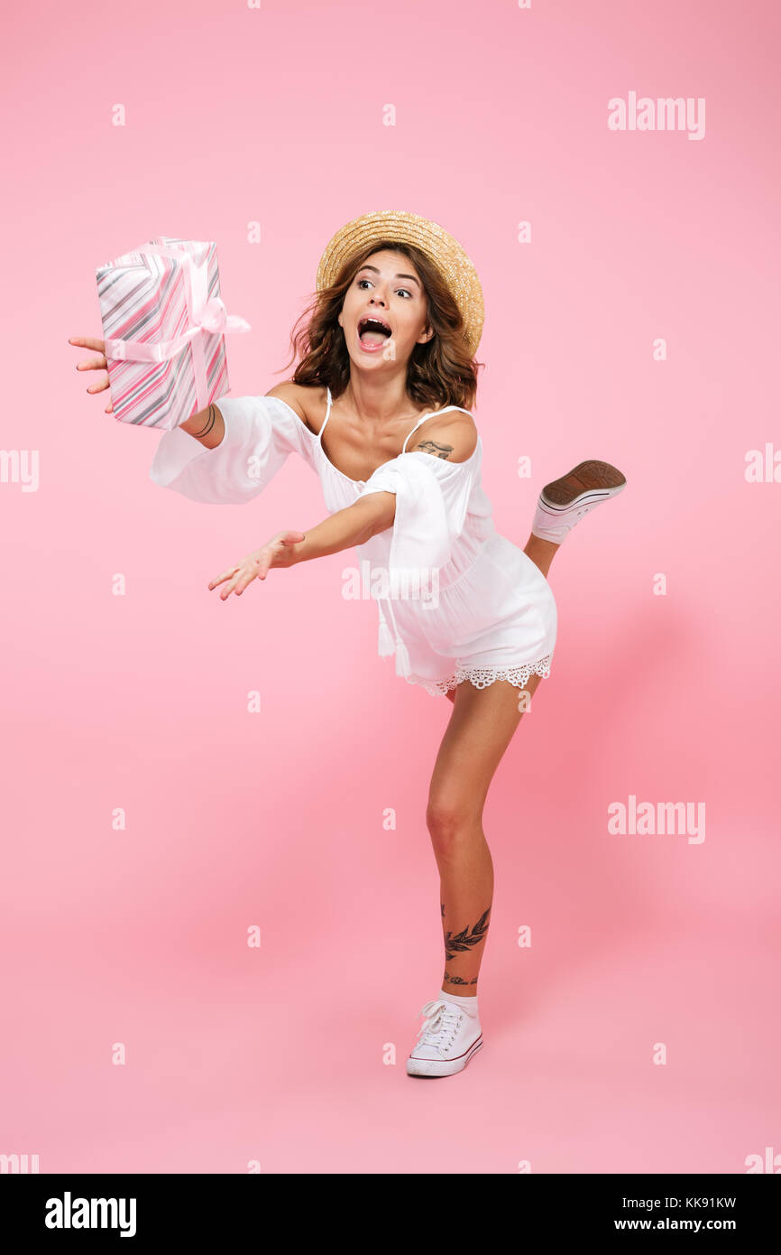 Full length portrait of a happy excited girl standing and catching ...