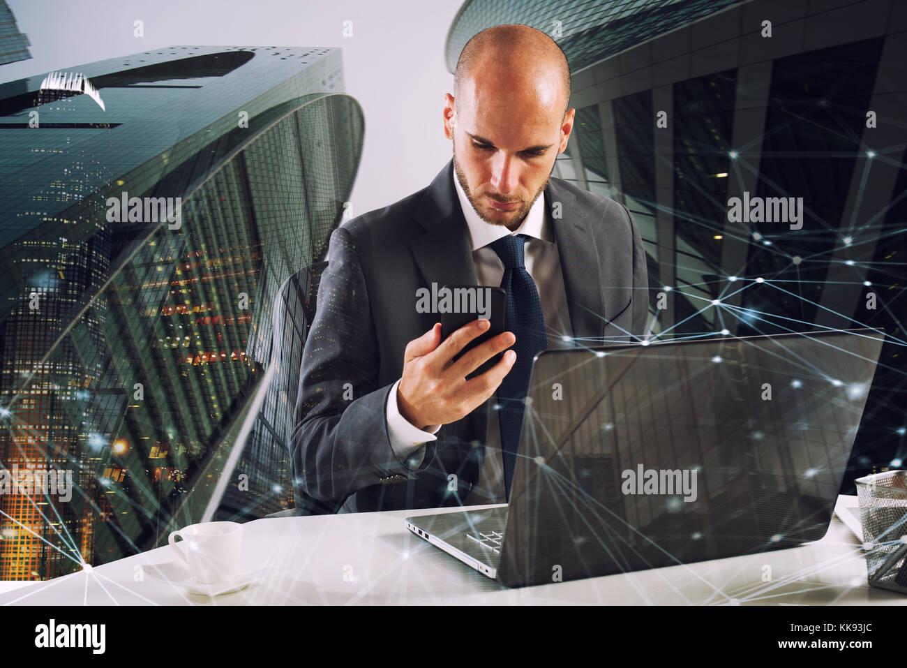 Businessman works with smartphone and laptop Stock Photo - Alamy