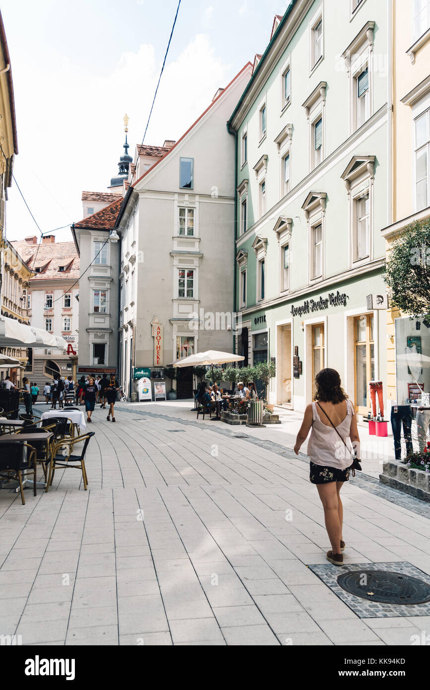 Woman walking on street in Graz Stock Photo - Alamy