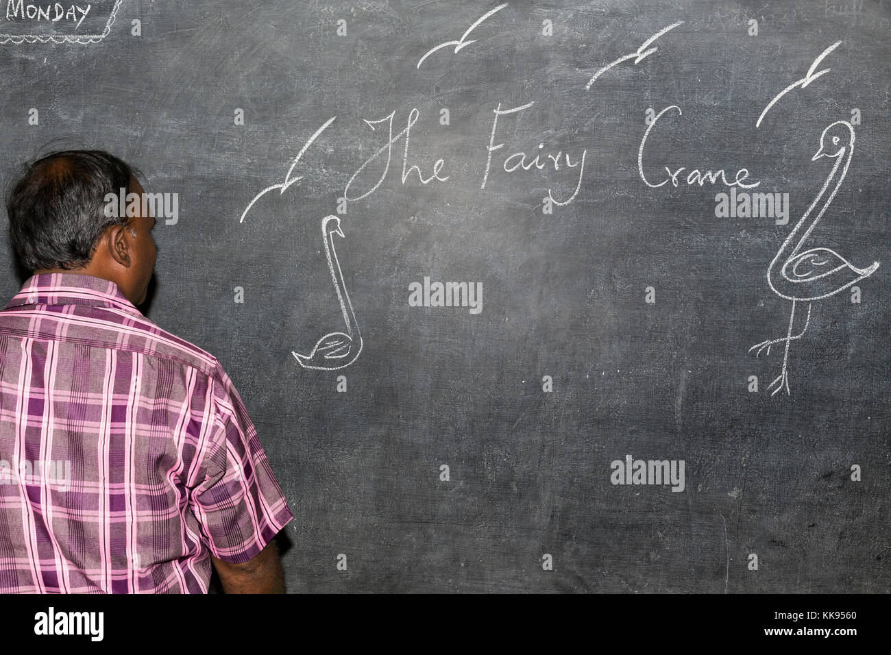 Man teacher writing on blackboard at classroom, India Stock Photo - Alamy