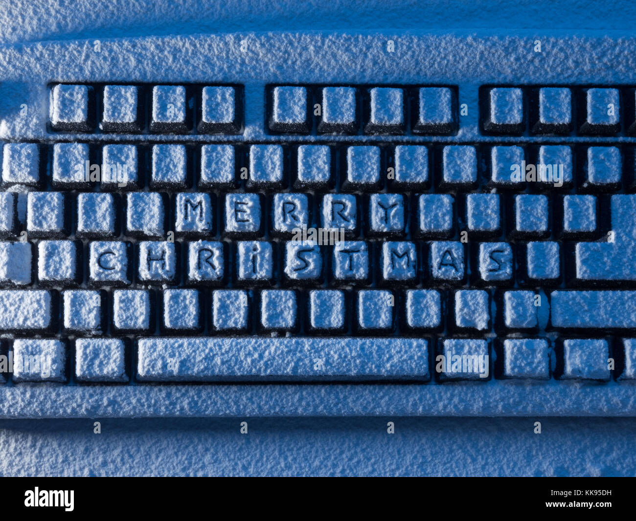 computer keyboard with text merry christmas on buttons covered with ...