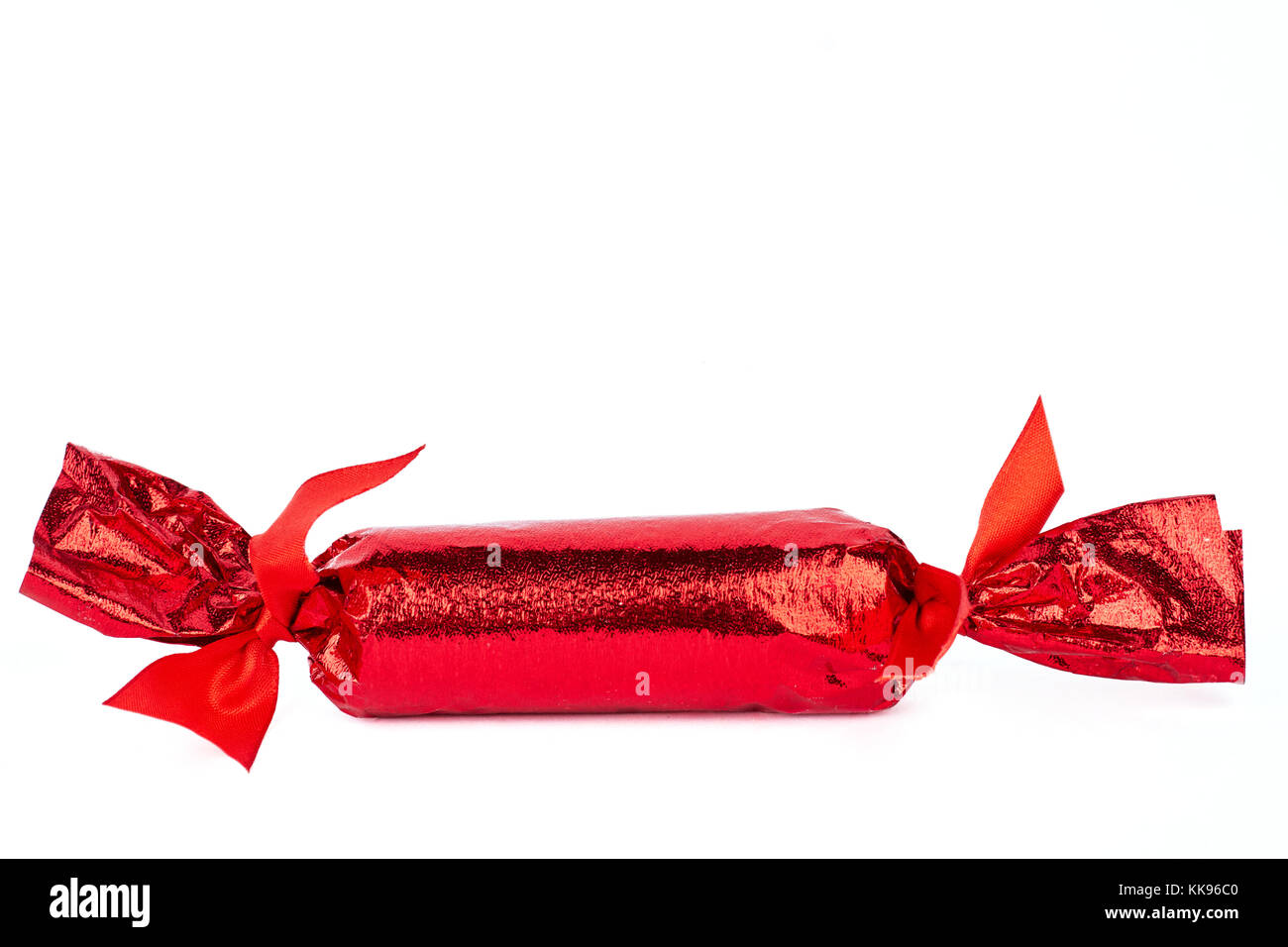 Candy in red paper on white background Stock Photo - Alamy