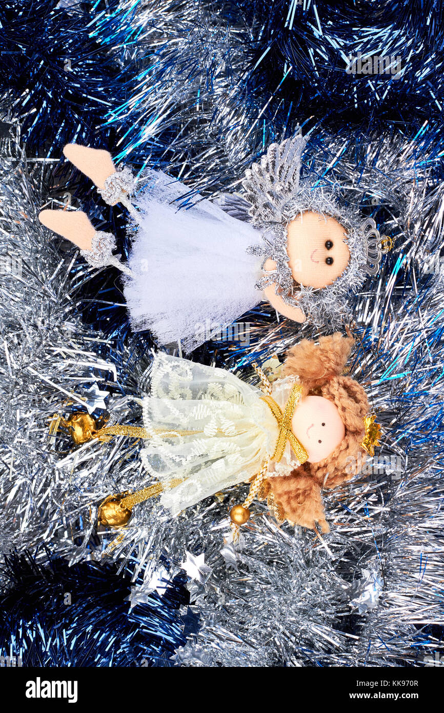 Two Christmas angels on tinsels background Stock Photo - Alamy