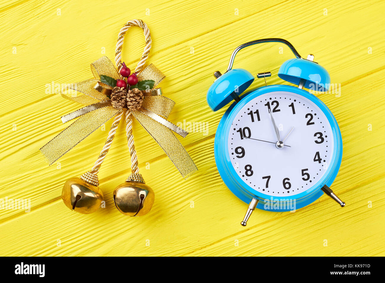 Golden bow with jingle-bell and alarm clock Stock Photo - Alamy