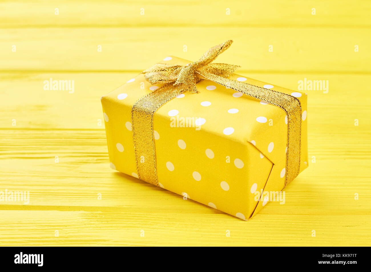 Yellow gift box on yellow background Stock Photo - Alamy