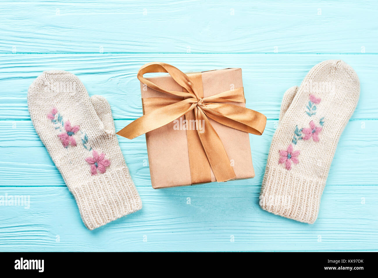 Gift box and pair of female knitted mittens Stock Photo - Alamy