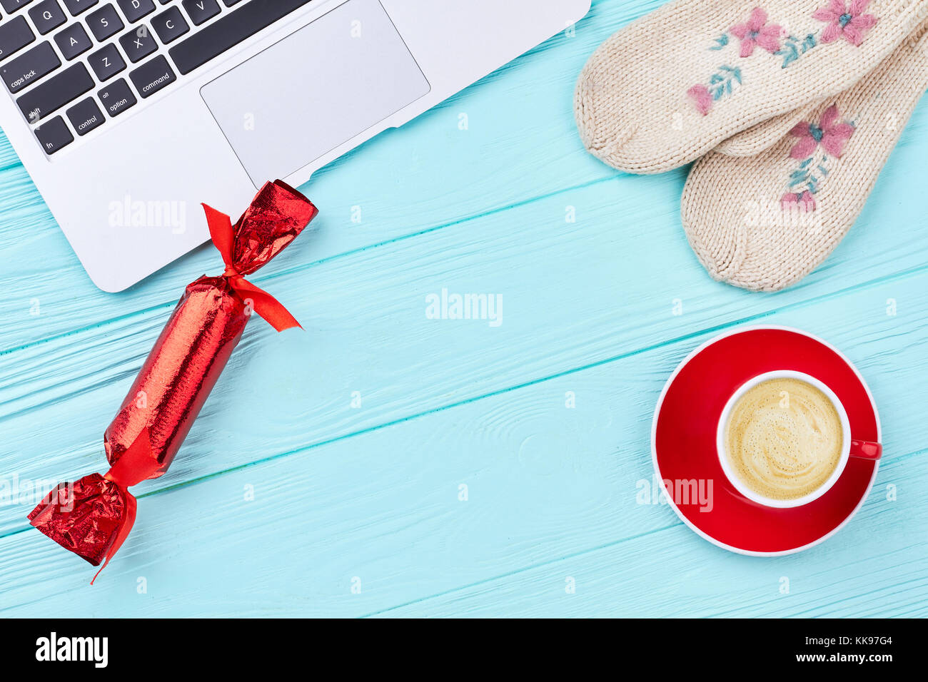 Computer laptop, handmade mittens, cup of coffee Stock Photo - Alamy